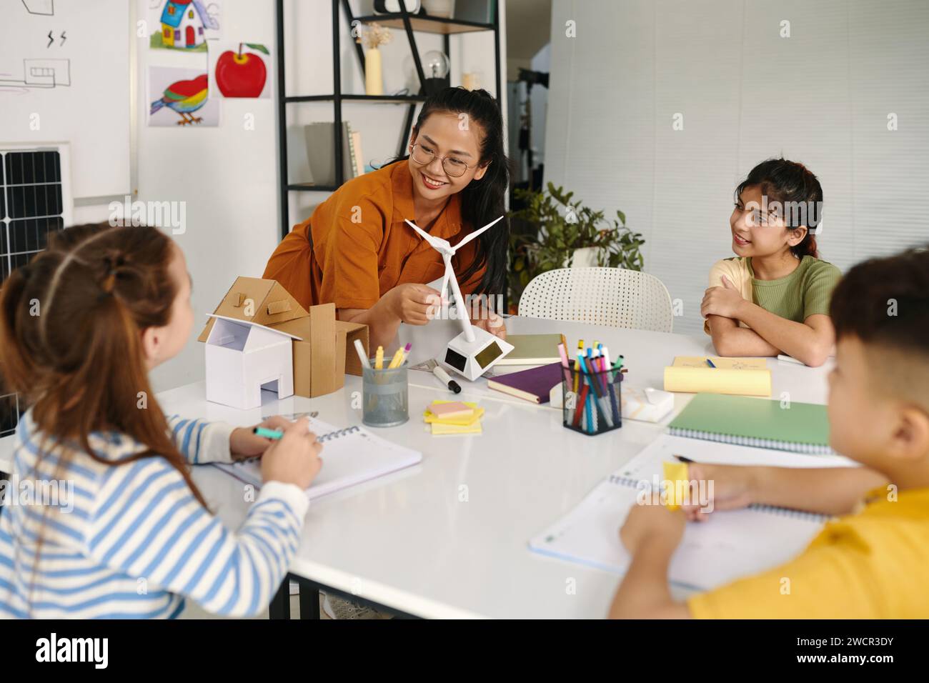 Group of kids learning about renewable energy in class Stock Photo - Alamy