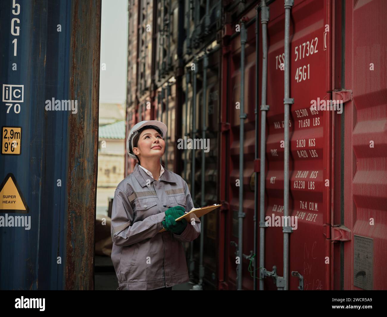 Portrait of a female worker holding clipboard while standing outside a ...
