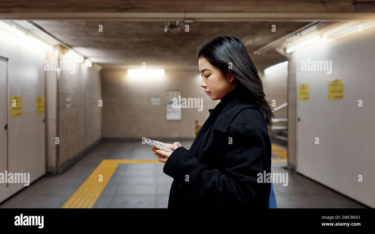 Phone, subway and Japanese woman on internet, social media and walking ...