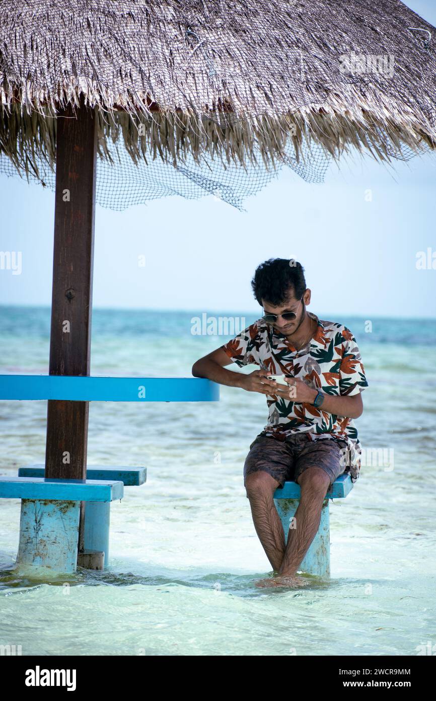 Picture of an Indian guy siting in a palm hut shade in the beaches of ...