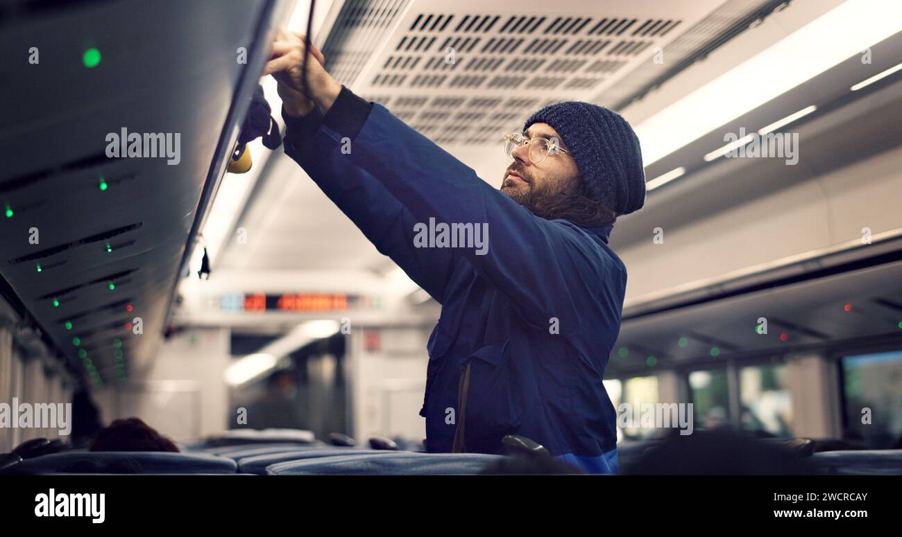 Man, train travel and overhead luggage compartment for storage, safety ...