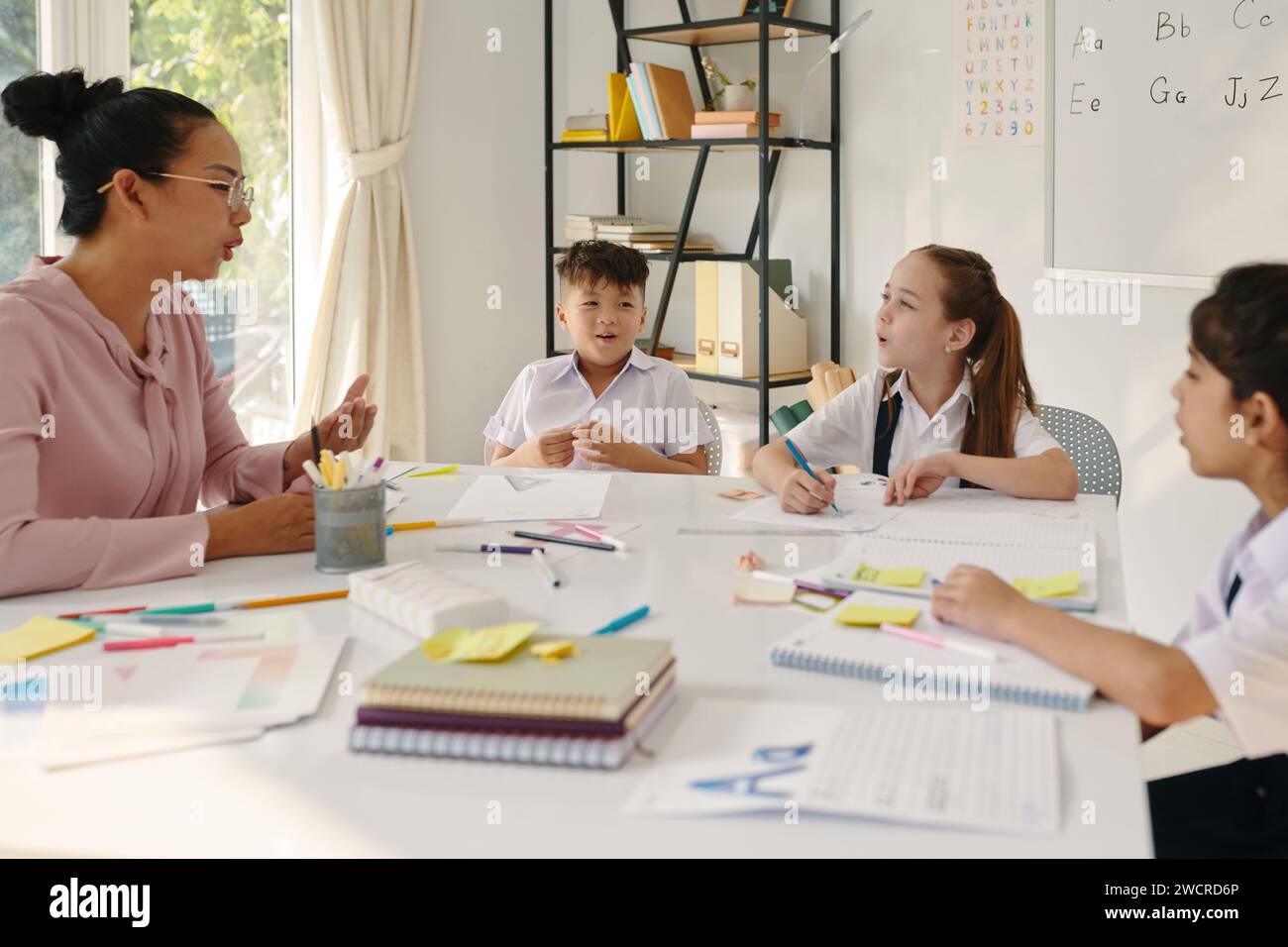 Kids repeating after teacher when practicing letter pronunciation Stock ...