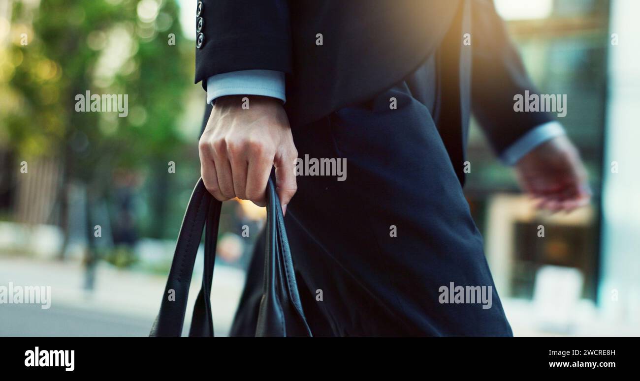Legs, walking and person with bag, travel in city street and carbon ...