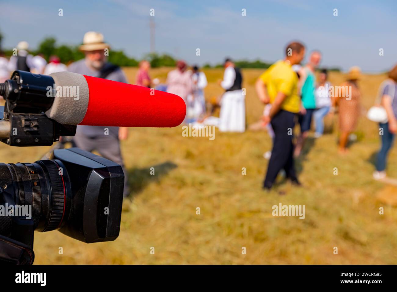 The video camera with the microphone is standing on the tripod ...