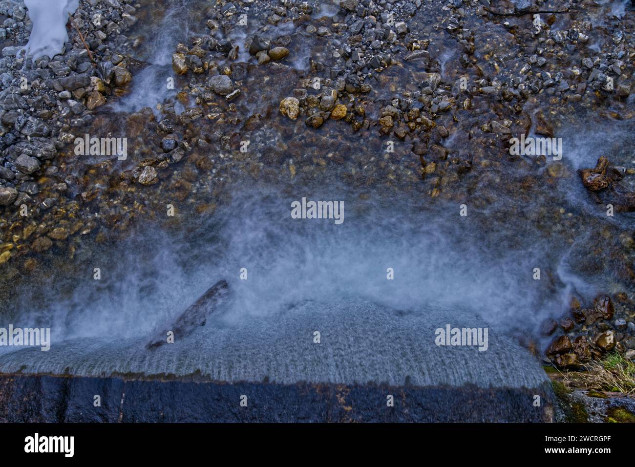 An aerial view of a picturesque stream meandering over rocks Stock ...