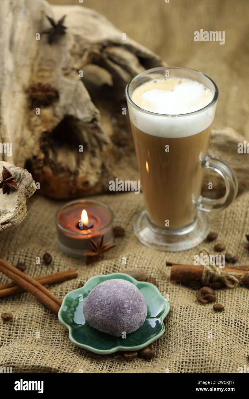 Glass coffee with mochi and spices. Cloth background with copy space ...
