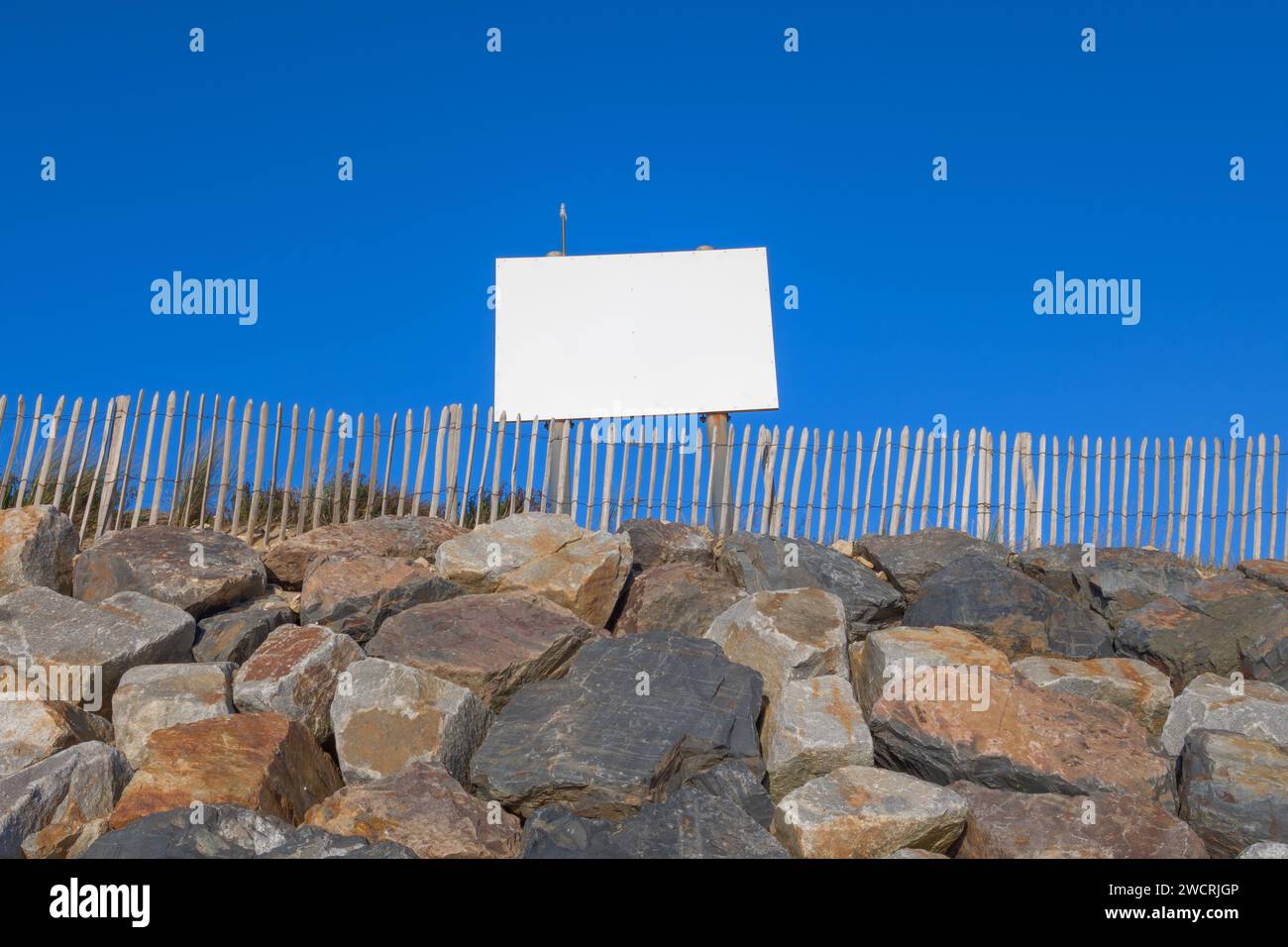 empty advertising panel mockup on the rocky sea beach front coast for ...