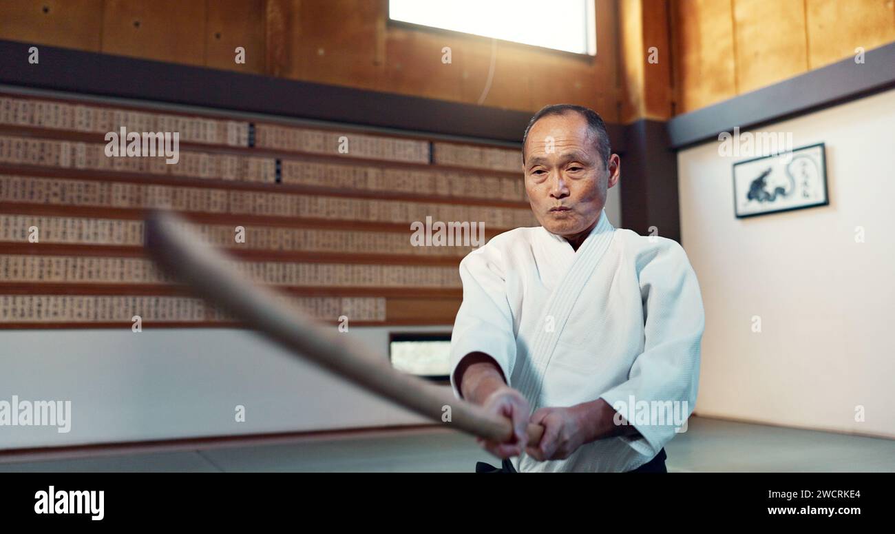 Aikido sword, martial arts and mature man strike for training, self defense or combat technique ...