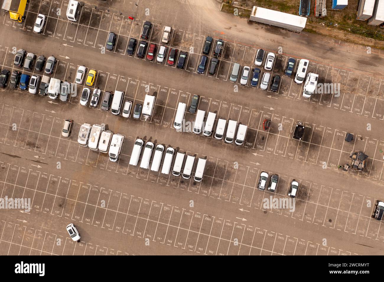 Drone photography of large car park lot with parked cars during autumn ...