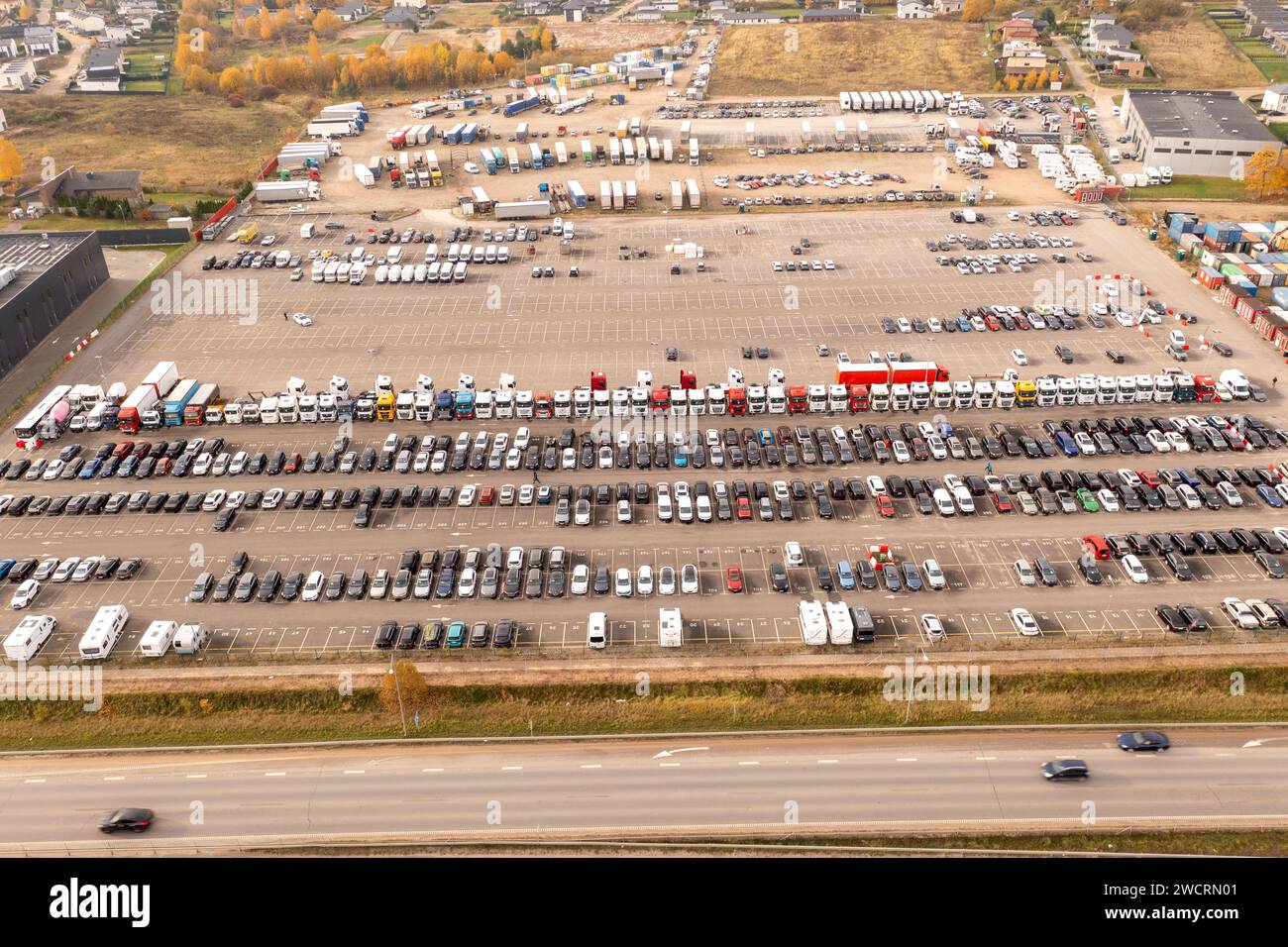 Drone photography of large car park lot with parked cars during autumn ...