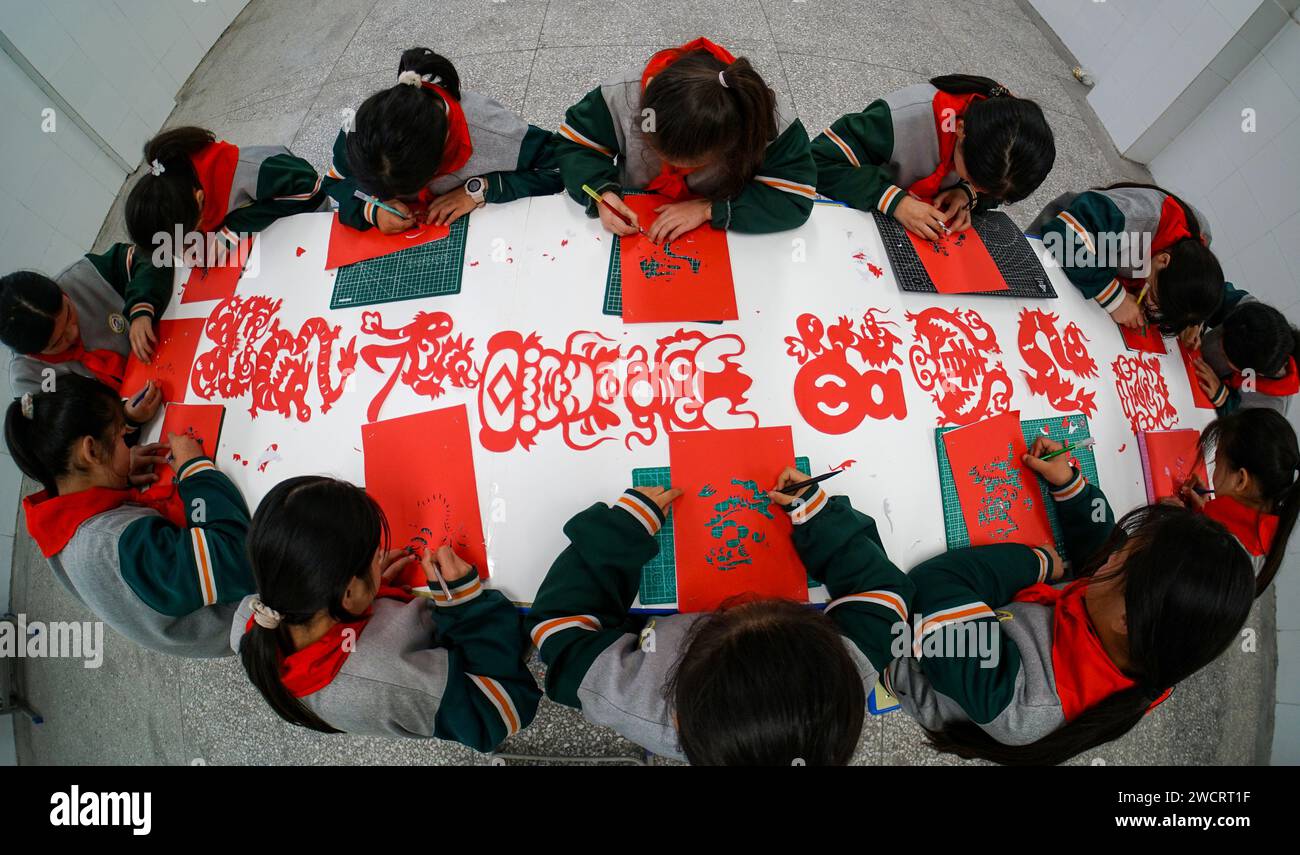 SUQIAN, CHINA - JANUARY 17, 2024 - Children from a paper-cutting club ...