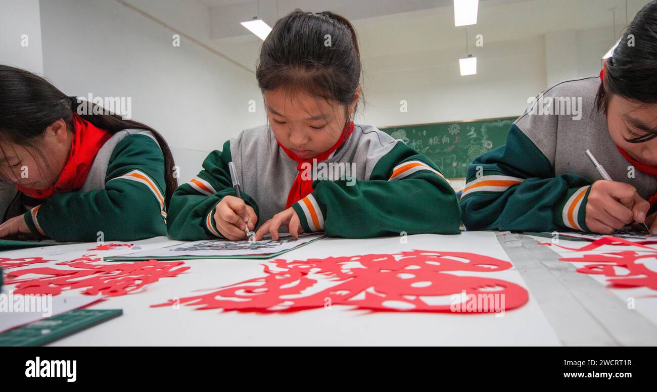 SUQIAN, CHINA - JANUARY 17, 2024 - Children from a paper-cutting club ...