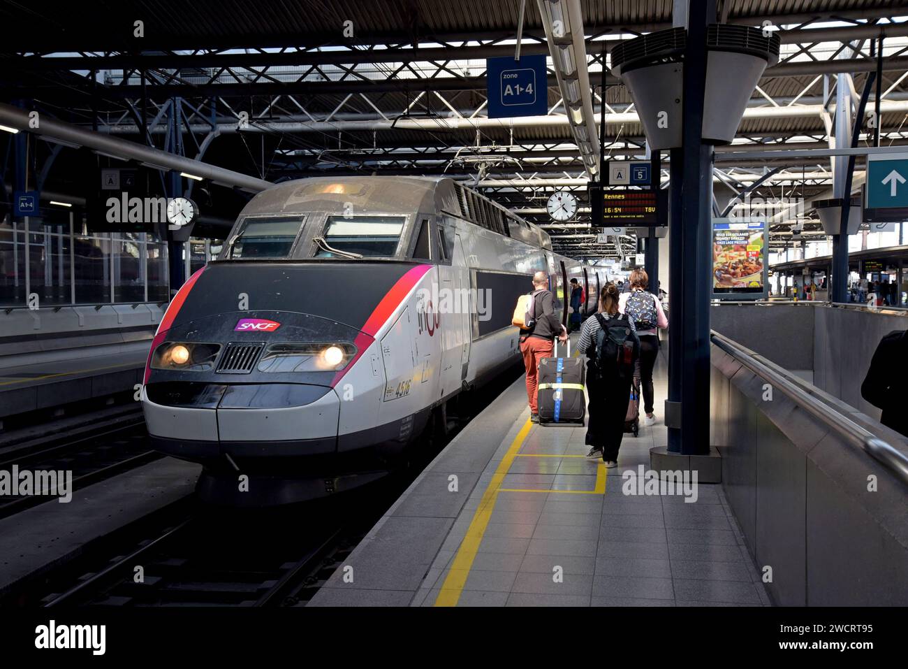 Passengers getting on a French SNCF TGV inter city high speed train to ...