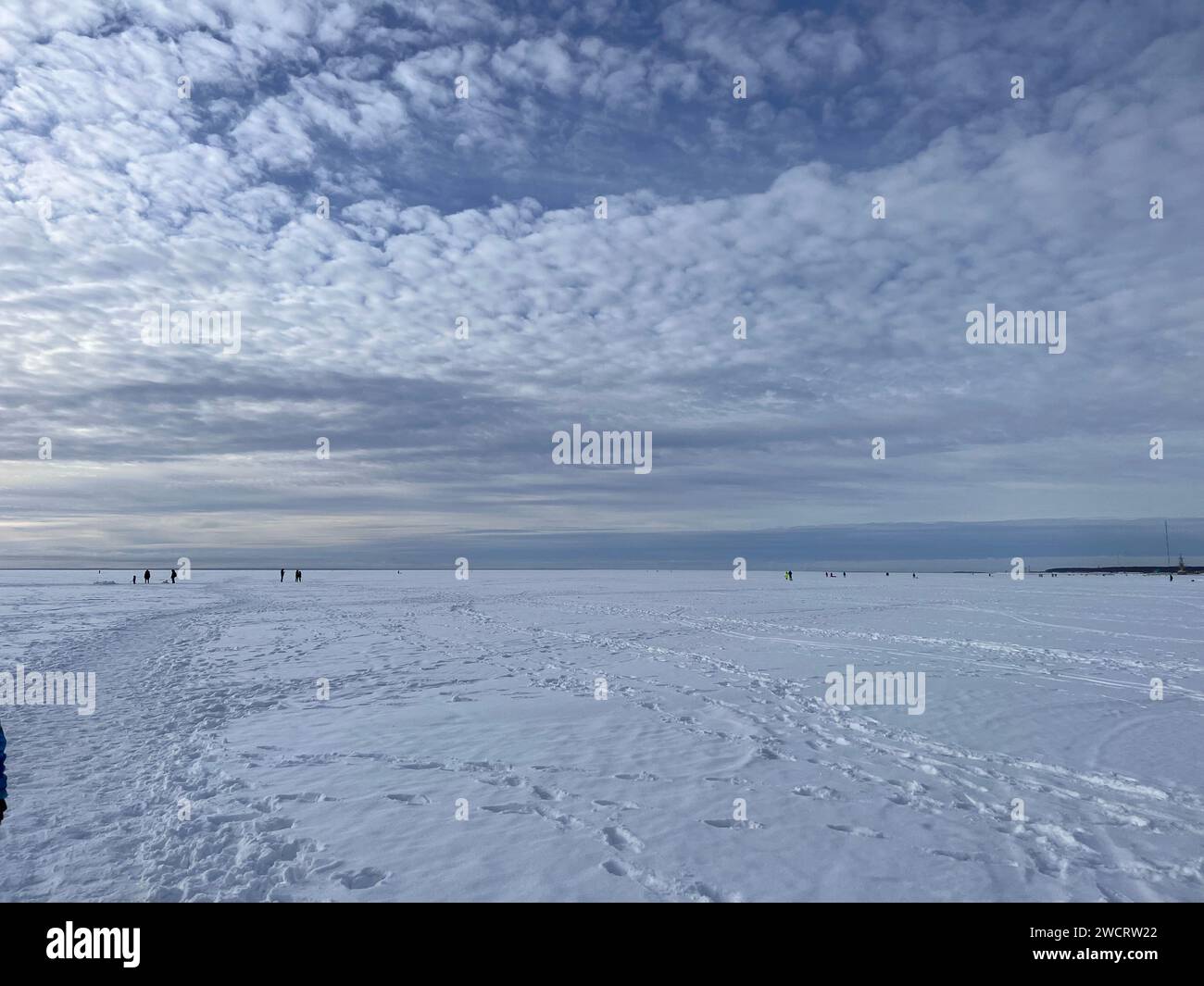 snow valley of frozen finland gulf. Beautuful spindrift clouds on blue ...