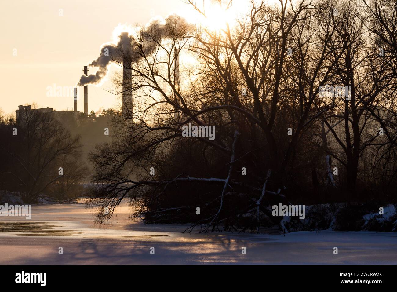 Smoking boiler room pipes behind a natural winter landscape Stock Photo ...