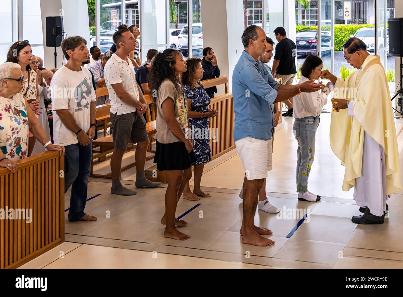 Priest giving communion at Mary Help of Christians Catholic Church, Ko ...