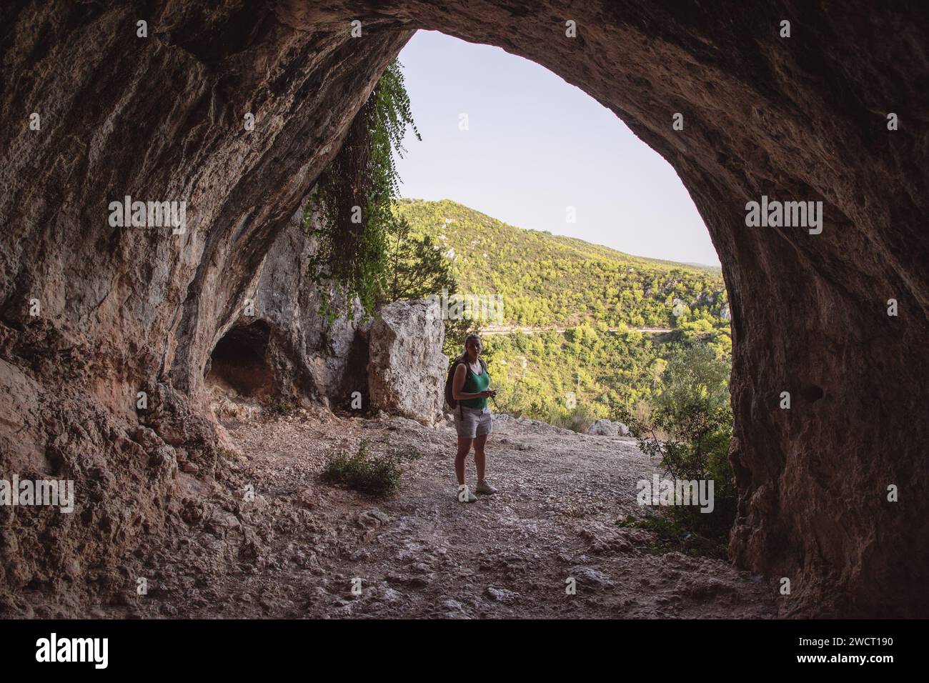 woman tourist exploring a cave Stock Photo - Alamy