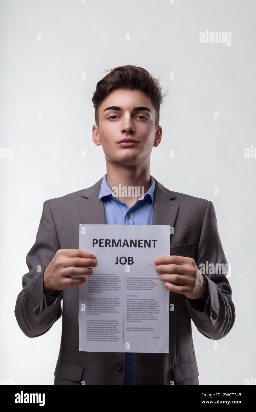 With poised assurance, a man showcases his 'Permanent Job' document ...