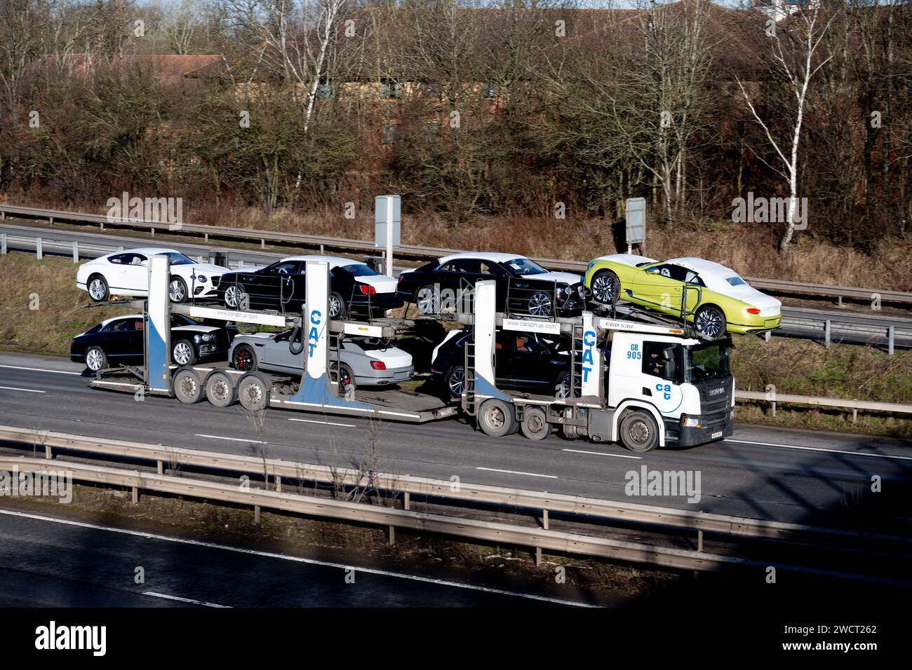 CAT transporter lorry carrying new Bentley cars on the M40 motorway ...