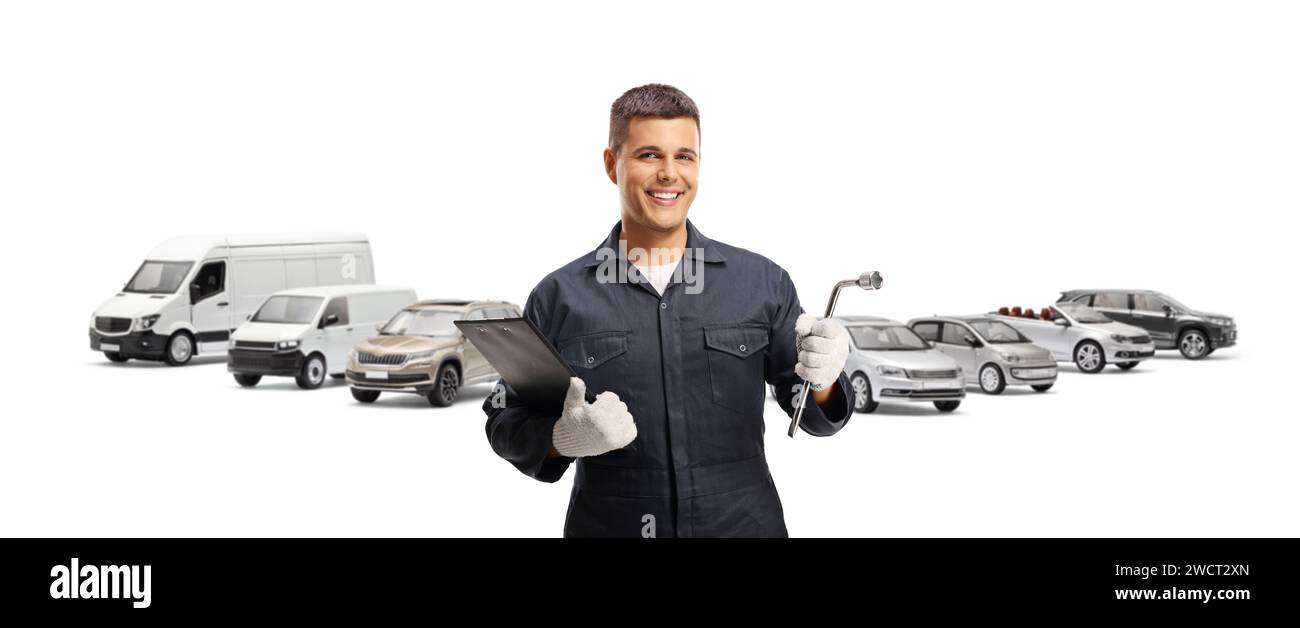 Auto repair worker holding tools in front of parked vehicles isolated ...