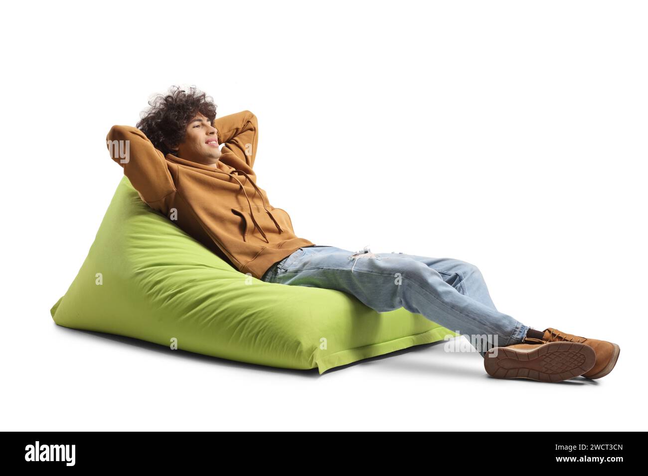 Generation z guy resting on a green bean bag armchair isolated on white ...