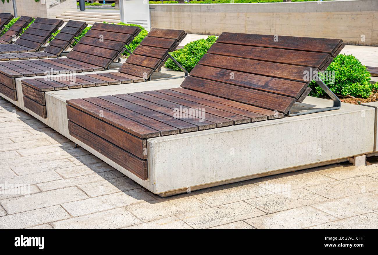 Bench in the street on the sidewalk of pavers Stock Photo - Alamy