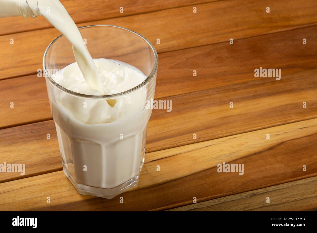 Filling glass of milk. Fresh milk Stock Photo - Alamy