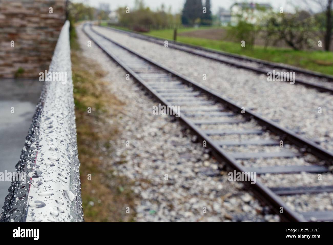 Train tracks in Radenci with some rain water droplets on the railing ...