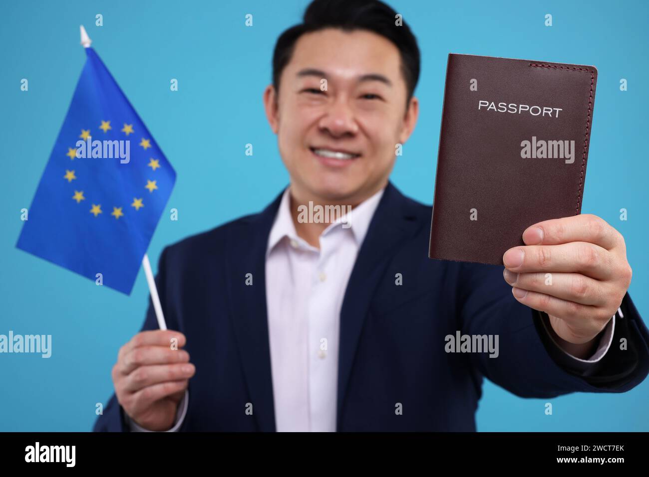 Immigration. Happy man with passport and flag of European Union on ...