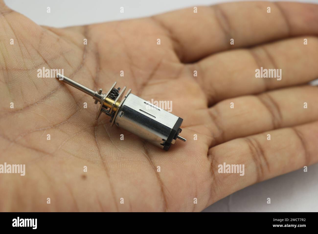 Micro metal gear box dc motor held in the hand. Mini dc motor with ...