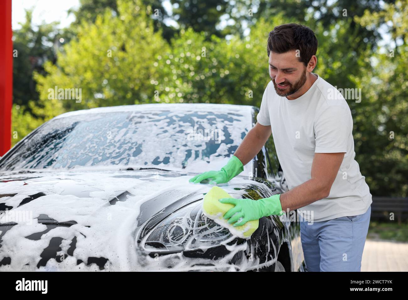 Happy man washing car hi-res stock photography and images - Alamy