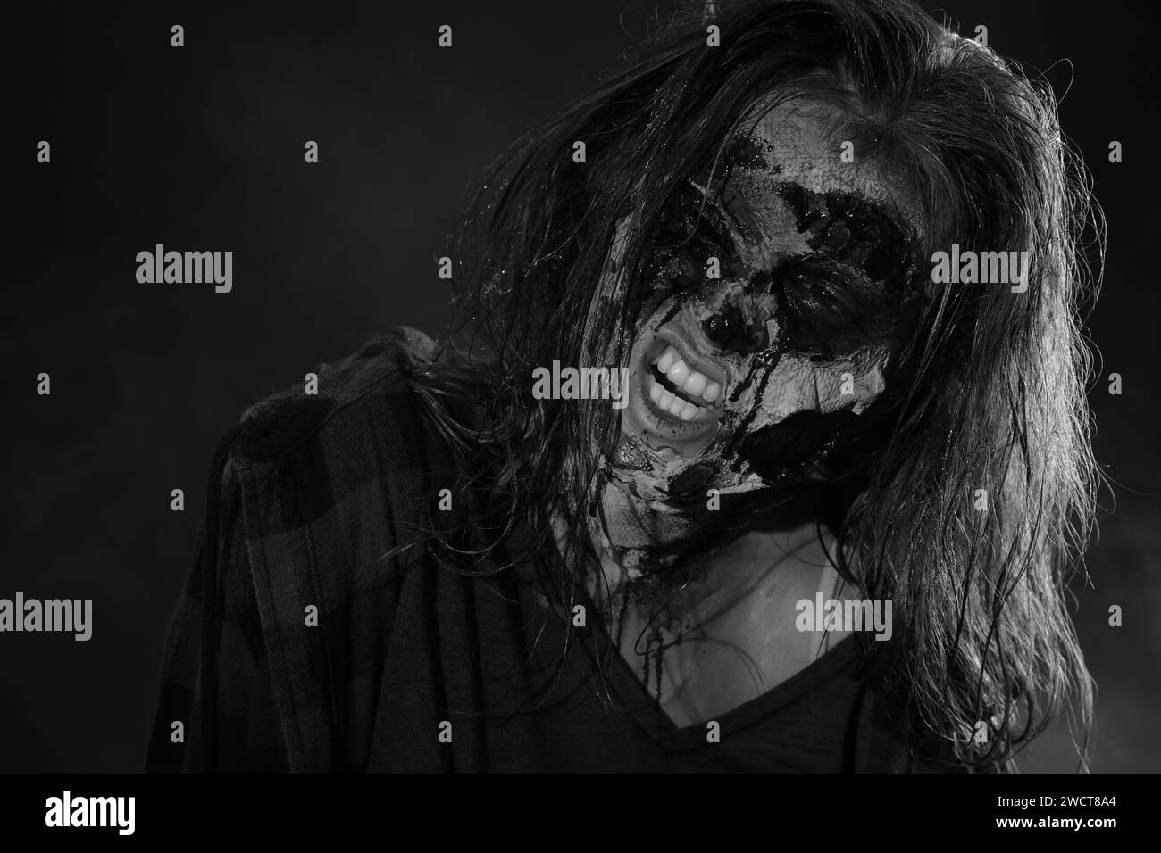 Scary zombie on dark background, black and white effect. Halloween ...