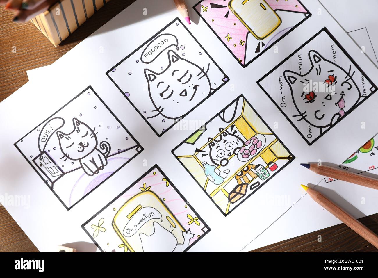 Storyboard with cartoon sketches at workplace, flat lay. Pre-production ...