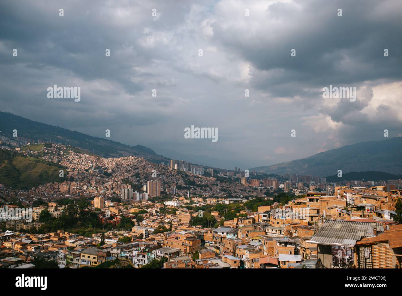 A panoramic view of a densely populated city sprawling across hilly ...