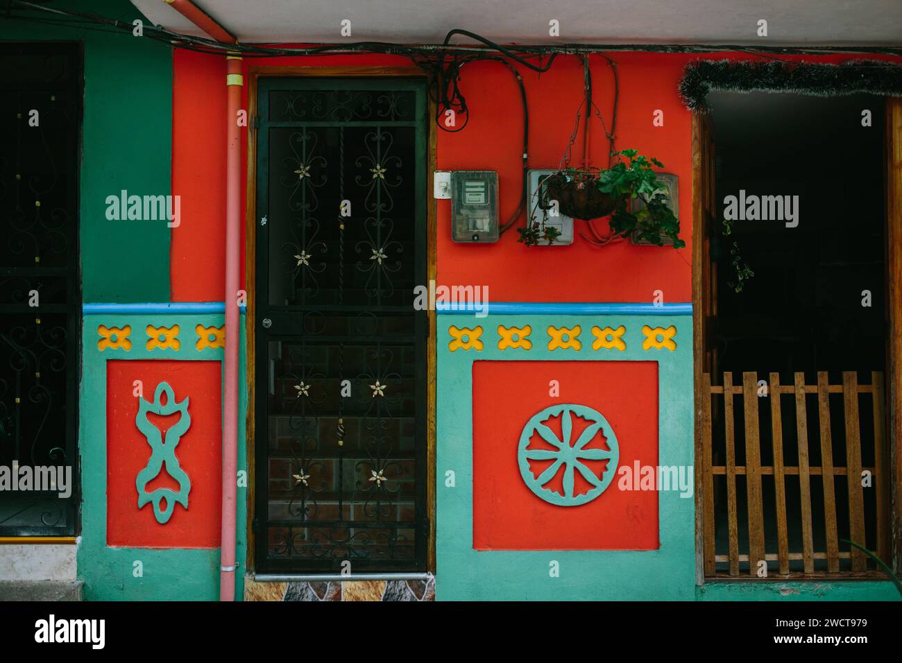 Vibrant traditional house facade featuring a patterned door and adorned ...
