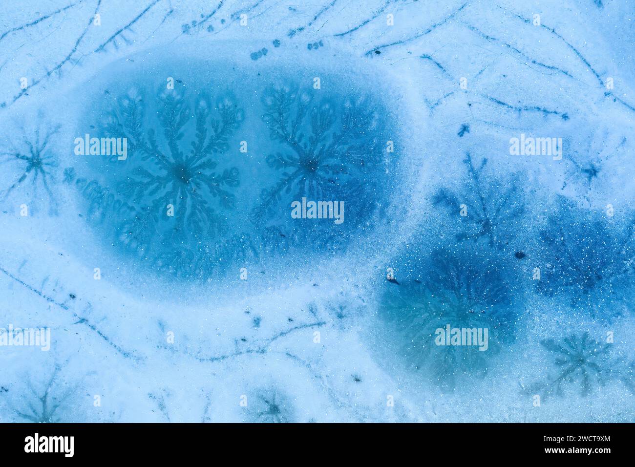 Unique ice formations creating mesmerizing patterns on a frozen lake's ...