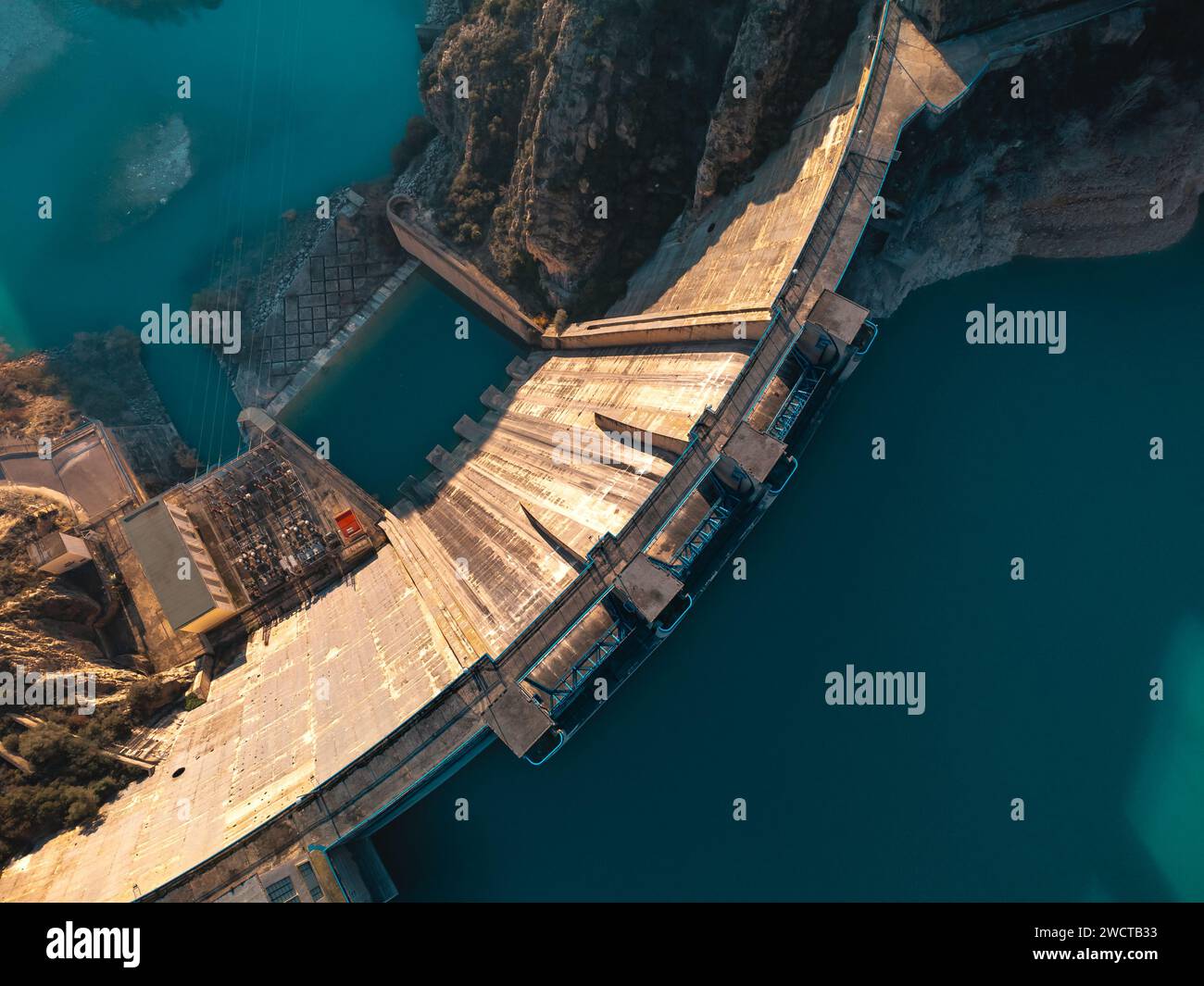 Top view of a massive dam structure with a reservoir in the mountains ...