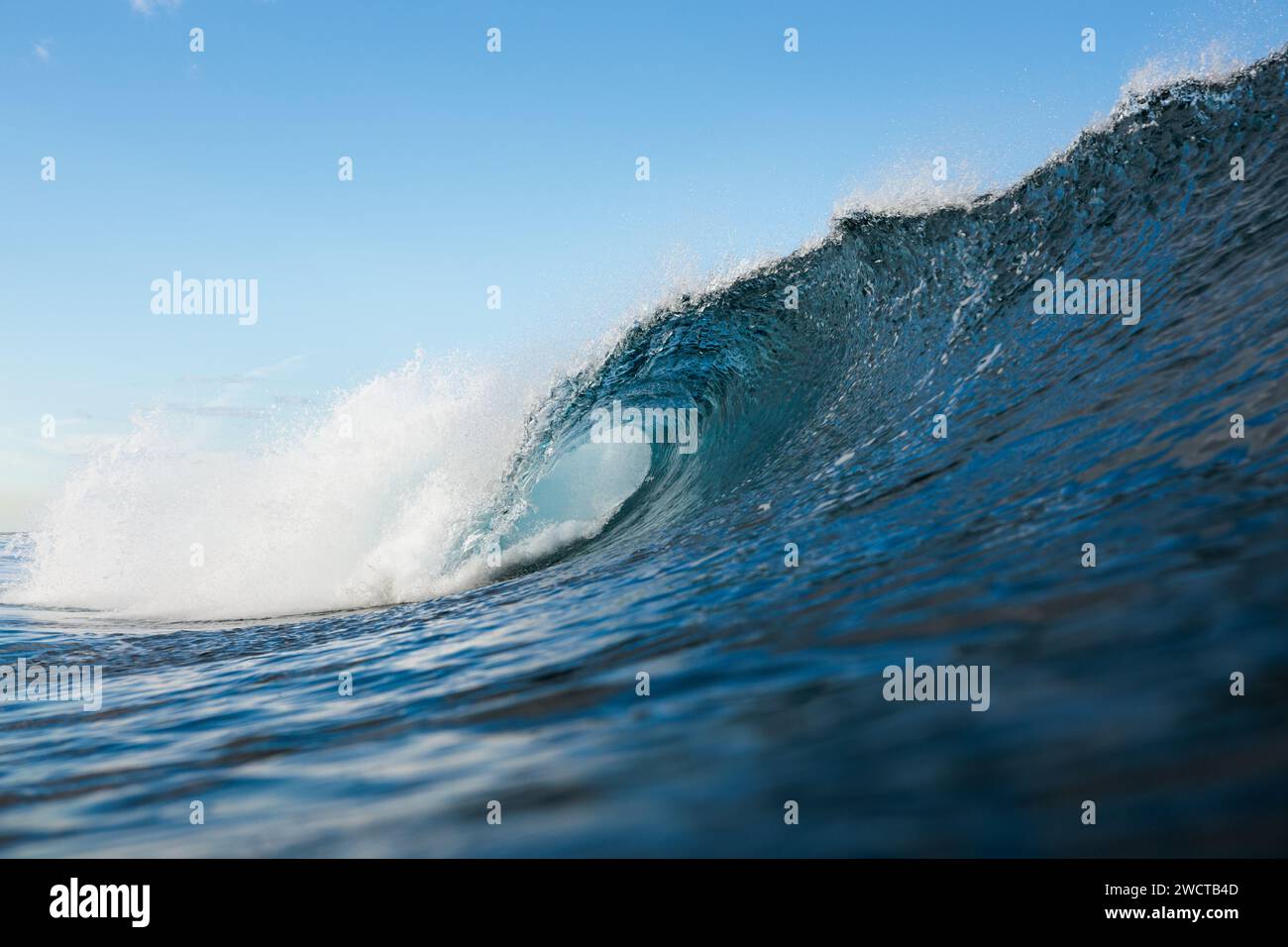 A dynamic ocean wave about to break, taken from the water's surface ...