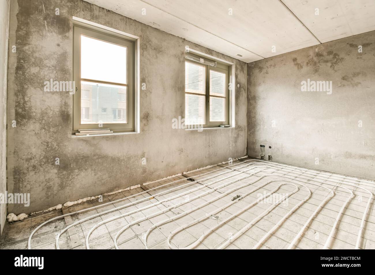 An unfinished room with underfloor heating system before the final ...