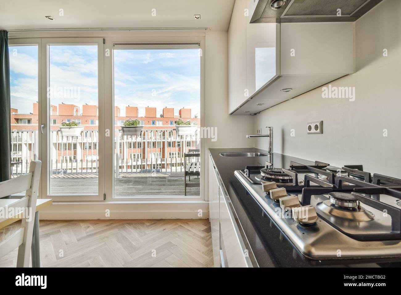 Bright and contemporary kitchen featuring a gas stove, sleek ...