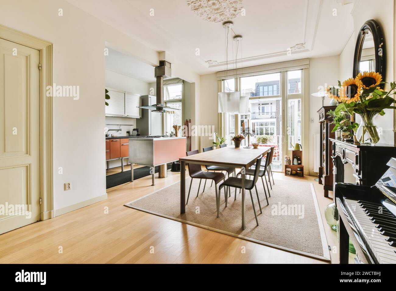 Bright and spacious dining room with an adjoining open kitchen and a ...