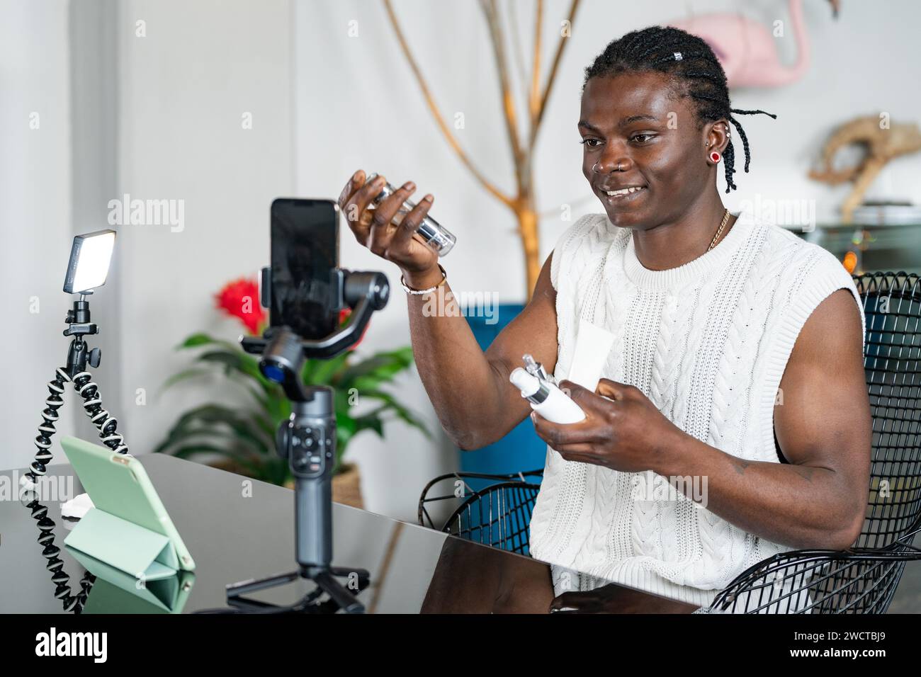 Animated black man reviews skincare products during a video shoot with ...