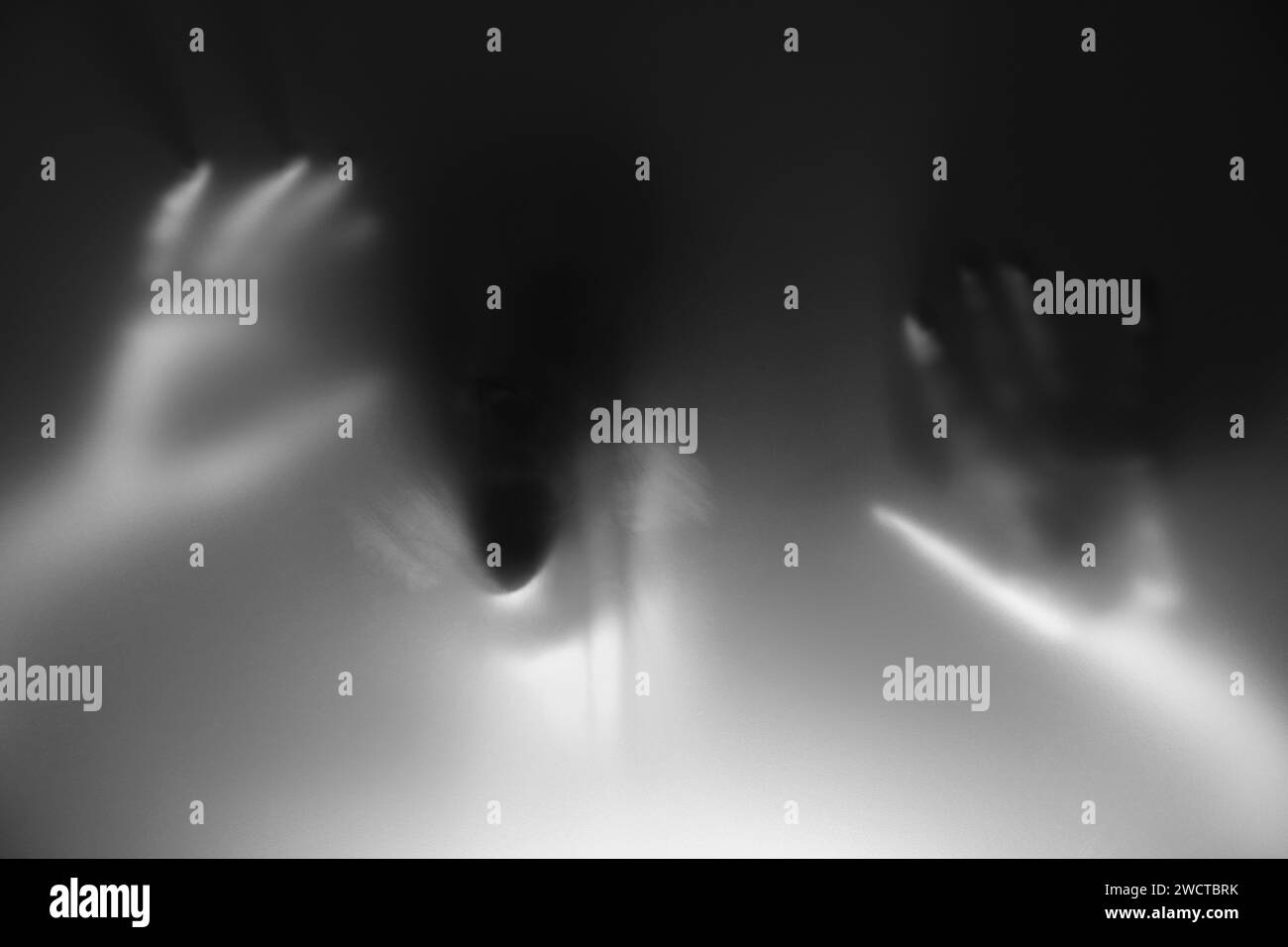 Silhouette of creepy ghost behind glass against grey background Stock ...