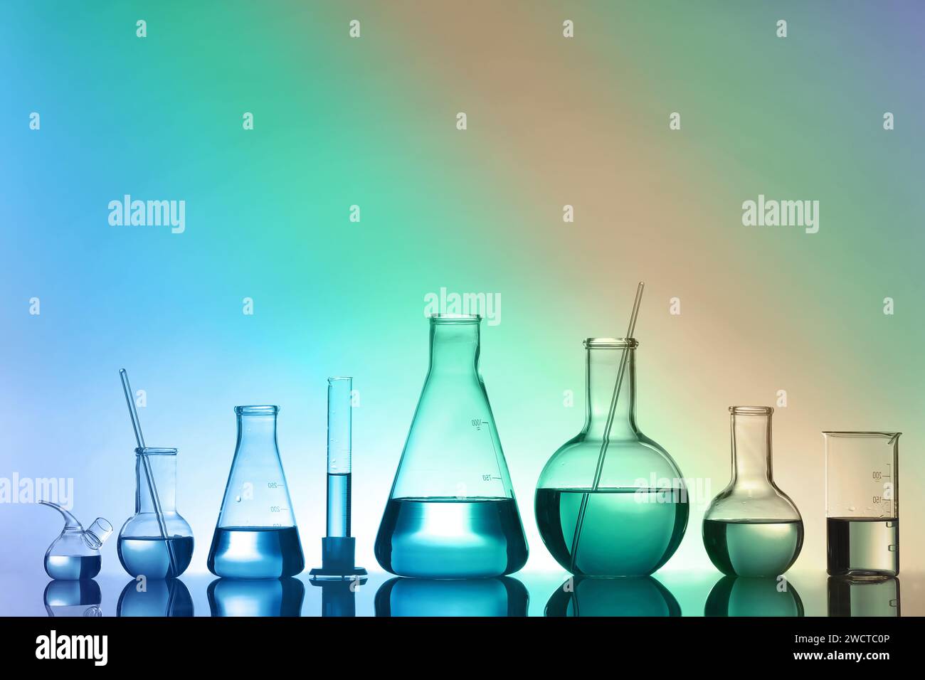 Laboratory glassware with liquid on table. Color toned Stock Photo - Alamy