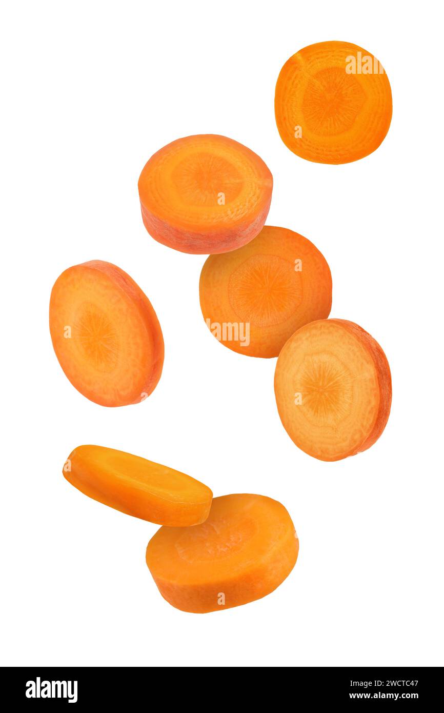 Fresh carrot slices falling on white background Stock Photo - Alamy