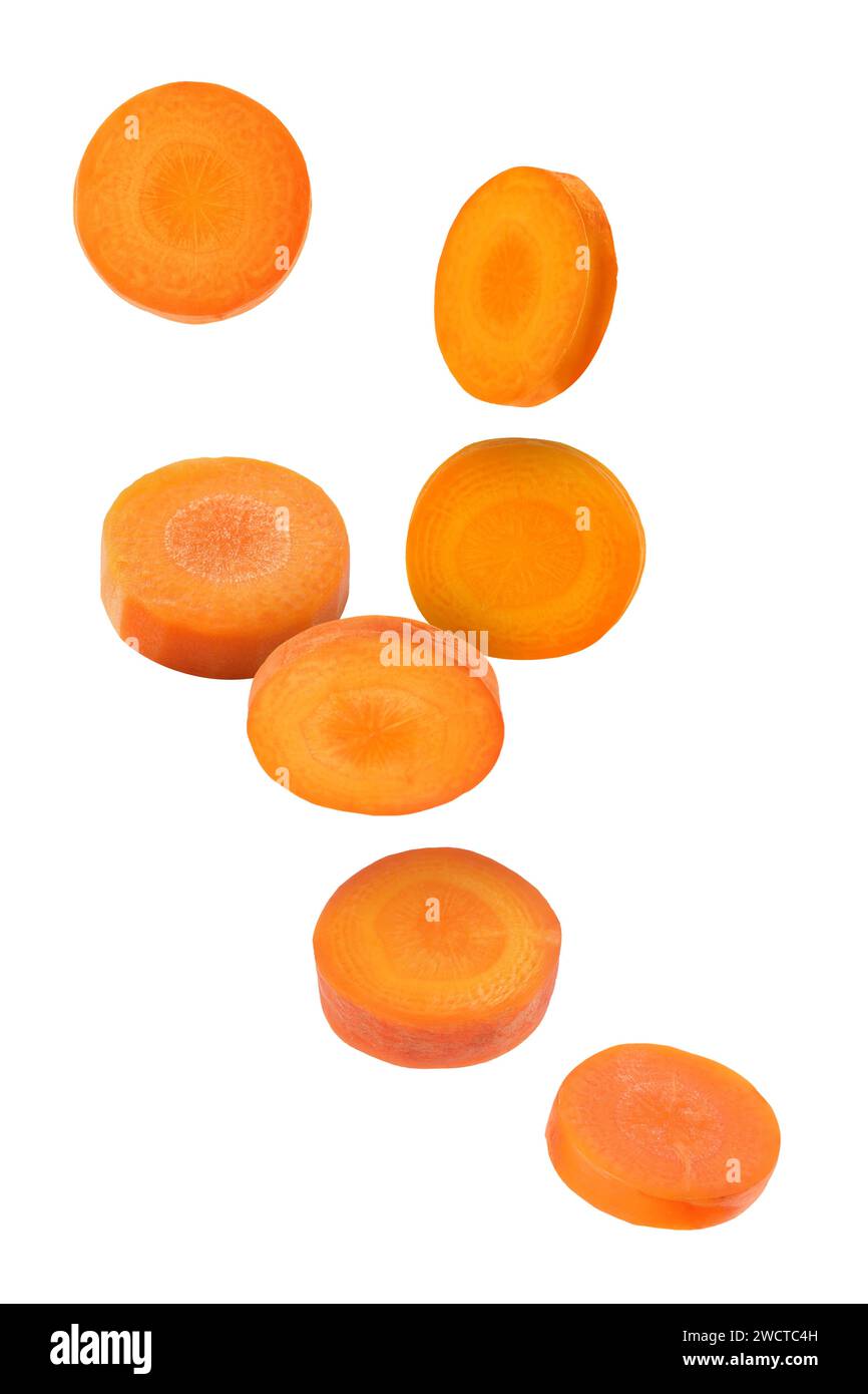 Fresh carrot slices falling on white background Stock Photo - Alamy