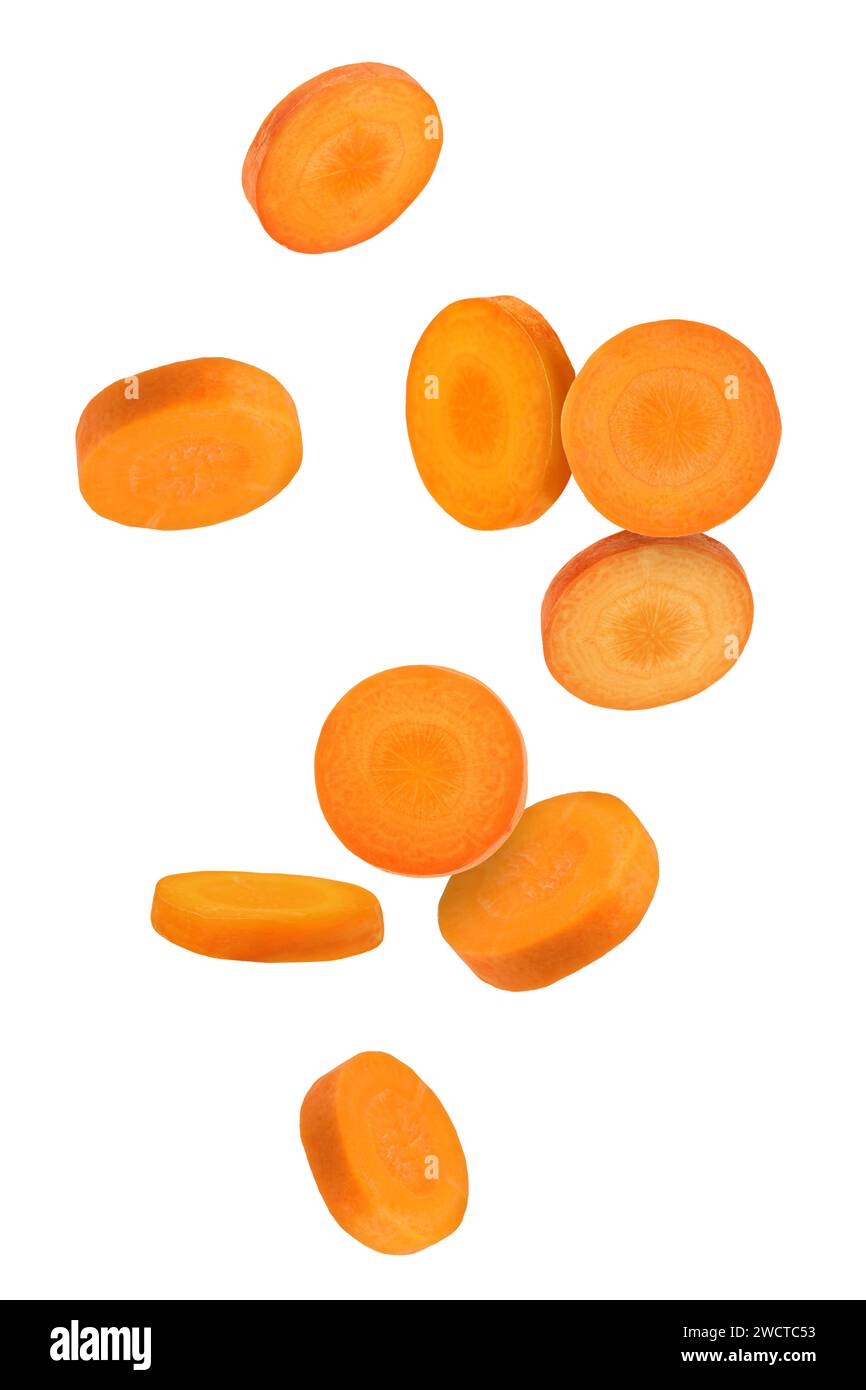 Fresh carrot slices falling on white background Stock Photo - Alamy