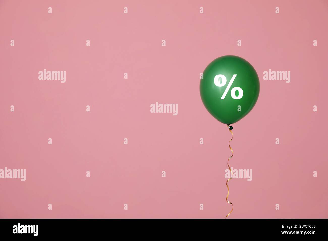 Discount offer. Green balloon with percent sign on pink background ...
