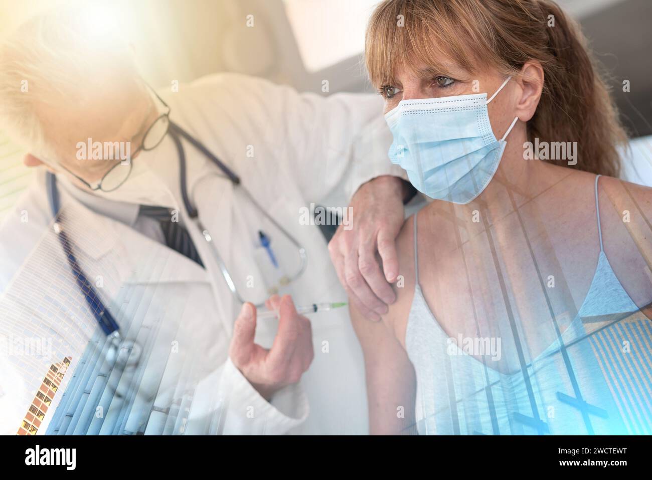 Doctor giving vaccin injection to female patient in medical office ...