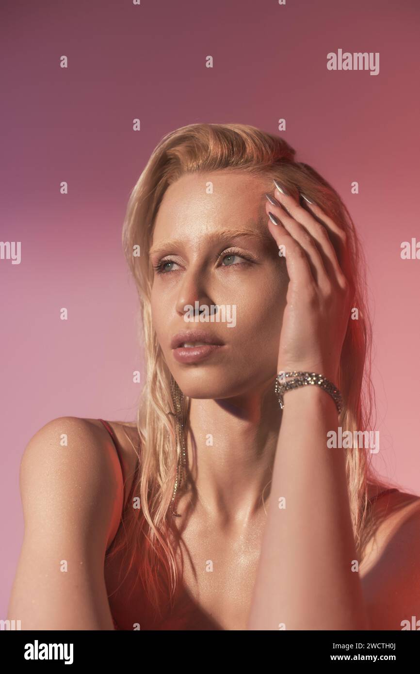 good looking young female model with accessories in red dress looking ...